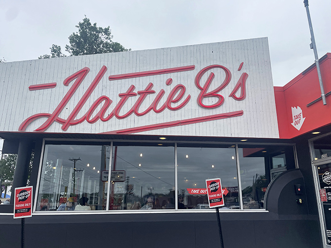 The black-and-white facade with that bold red ‘Hattie B’s’ sign isn’t just architecture—it’s Nashville’s equivalent of a lighthouse guiding hungry souls to spicy salvation.