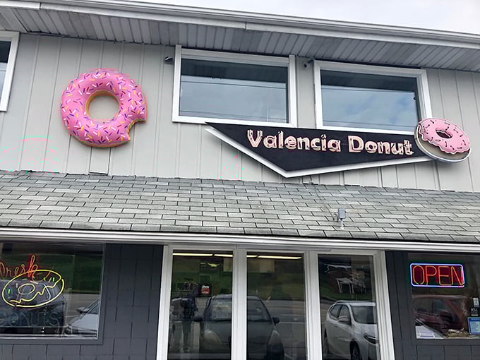 The pink donut signs adorning Valencia Donut's exterior aren't just decoration—they're beacons of hope for the breakfast-obsessed traveler on Pennsylvania's Route 8.