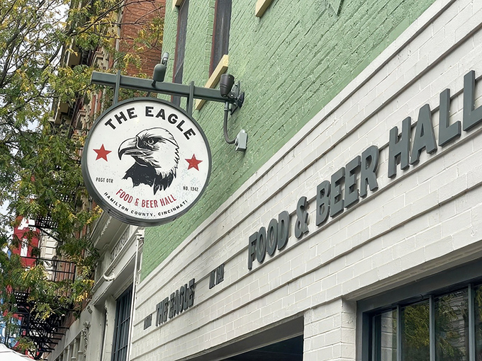The mint-green facade of The Eagle OTR stands out like a culinary beacon on Vine Street, promising Southern comfort with urban flair.