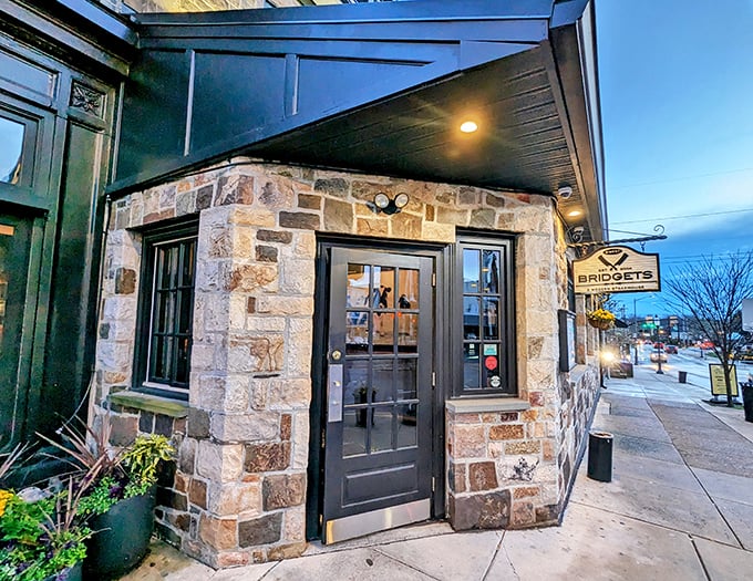 The stone façade of Bridget's Steakhouse welcomes you like an old friend, promising culinary magic behind that unassuming black door.