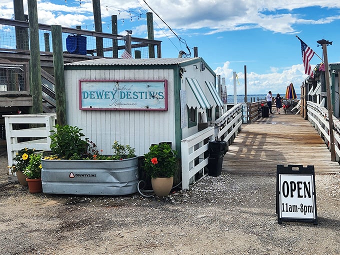 The entrance to paradise isn't pearly gates, but a weathered wooden boardwalk leading to Dewey Destin's—where seafood dreams come true and calories don't count.