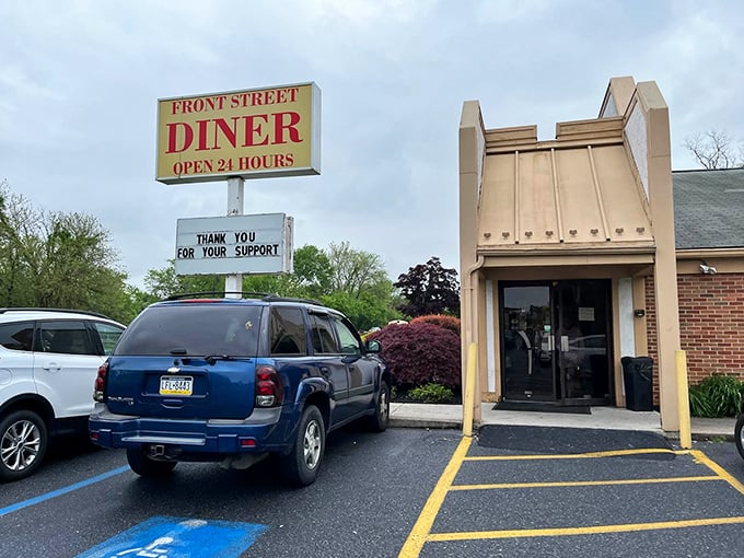 The iconic Front Street Diner sign promises "OPEN 24 HOURS" – a beacon of hope when hunger strikes at 3 AM and everywhere else has abandoned you.