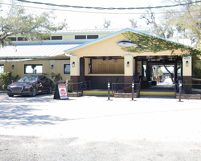 The unassuming entrance to Cap's On the Water belies the culinary treasures within. Like finding a pirate's chest disguised as a beach shack. 