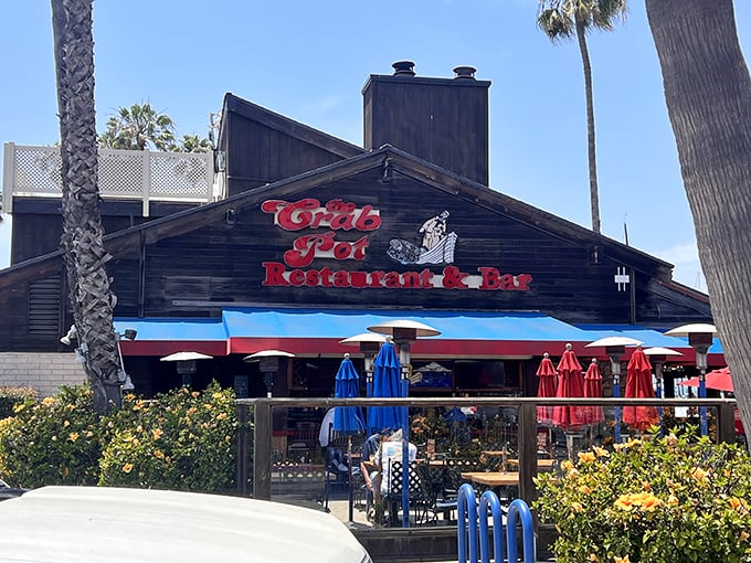 The iconic black exterior of The Crab Pot stands proudly against the California sky, like a treasure chest waiting to reveal its seafood bounty