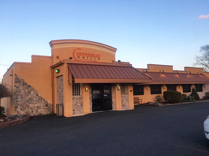 The terracotta-colored exterior of Copperhead Grille stands like a culinary oasis in Bethlehem, promising delicious treasures within those stone-accented walls.