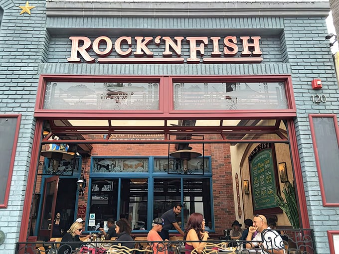 The iconic blue-bricked facade of Rock'N Fish stands out like a maritime jewel on Manhattan Beach, promising seafood treasures just steps from the Pacific.