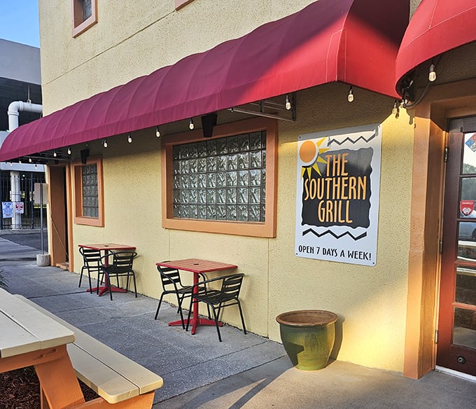 The unassuming yellow exterior with red awnings is like finding a treasure map where X marks the sandwich spot.