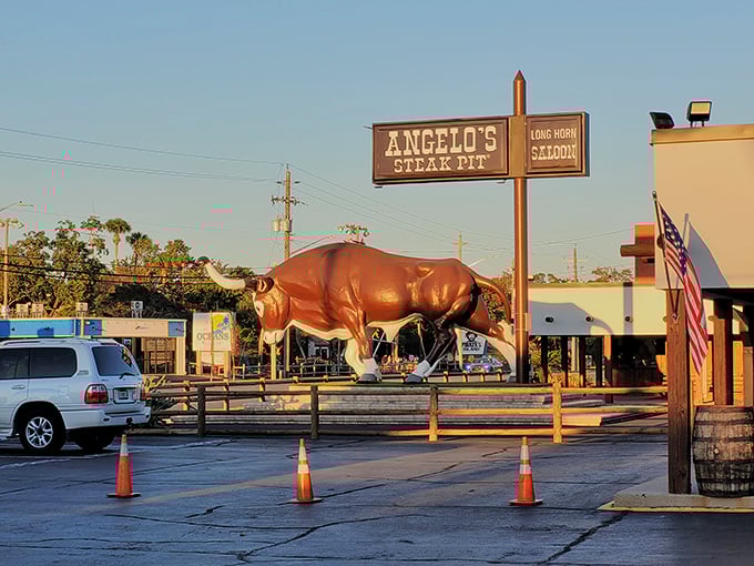 Angelo's iconic red bull statue stands guard outside, a beacon for hungry travelers seeking seafood treasures and sizzling steaks in Panama City Beach.