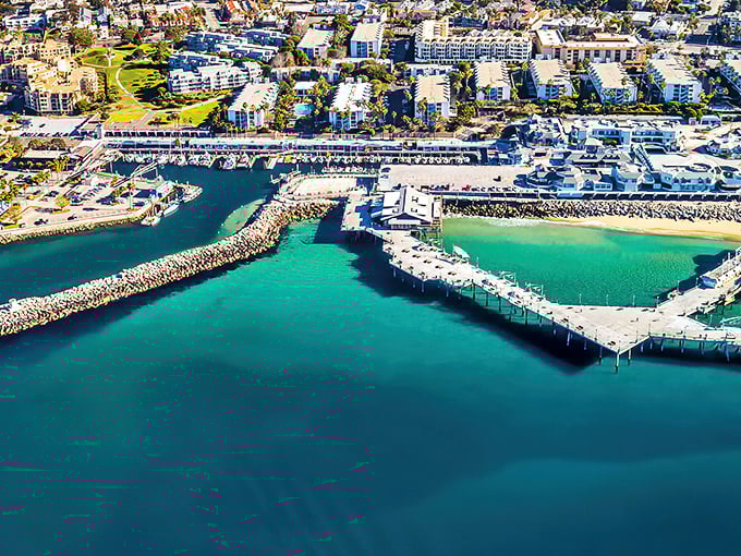 The marina's horseshoe shape creates a perfect turquoise embrace, like Mother Nature designed her own infinity pool with boats.
