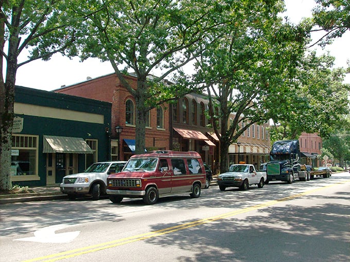 Towering oaks cast dappled shadows over Madison's historic storefronts, where time slows down and Southern charm thrives.
