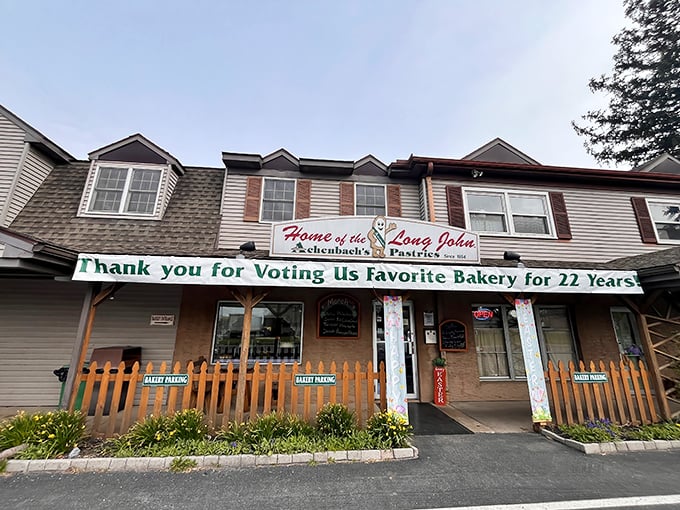 The unassuming exterior of Achenbach's proudly announces its status as "Home of the Long John" – a title earned through decades of pastry perfection.
