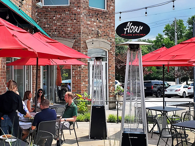 Flour's distinctive brick exterior with its elegant oval sign promises Italian delights within. Those red umbrellas aren't just for show—they're inviting you to linger over aperitivos on warm Ohio evenings.