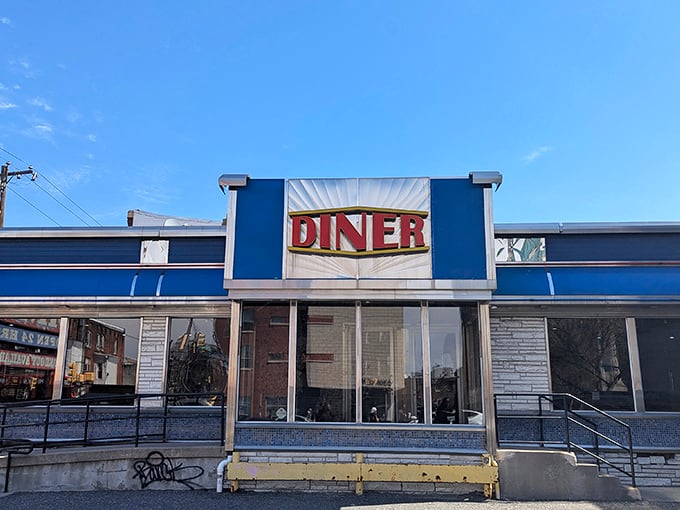 The iconic blue exterior of Broad Street Diner stands like a beacon of breakfast hope on a Philadelphia street corner, promising comfort food salvation to hungry travelers.