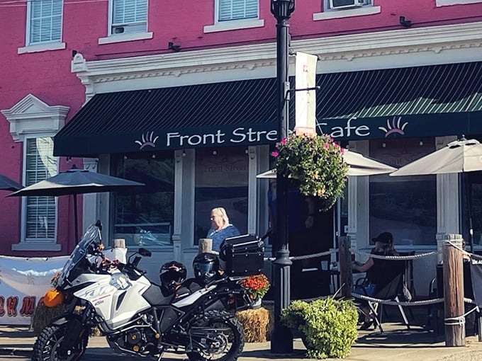 The salmon-pink exterior of Front Street Café stands like a culinary lighthouse on New Richmond's riverfront, beckoning hungry travelers with its charming historic façade.