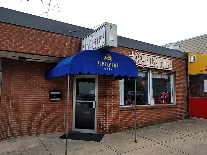 The iconic blue awning of Sinclair's Cafe stands out like a beacon for breakfast enthusiasts in Newark, promising comfort food salvation just steps away.