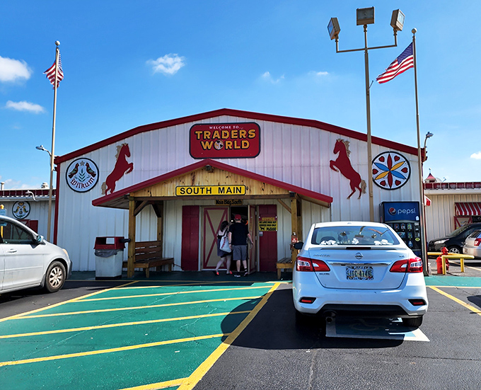 The iconic red and white entrance to Traders World beckons treasure hunters with its distinctive horse silhouettes—Ohio's retail rodeo where bargains await.