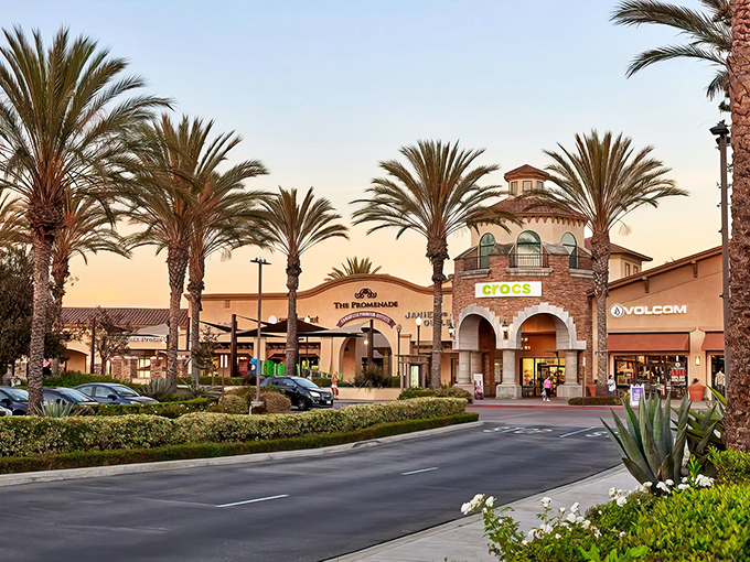 Palm trees frame the Mediterranean-inspired entrance to Camarillo Premium Outlets, where your wallet gets a vacation while your shopping addiction doesn't.