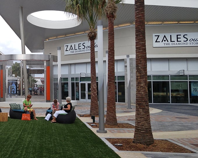Look at those shoppers relaxing on artificial turf – they've discovered the secret to outlet marathon training.