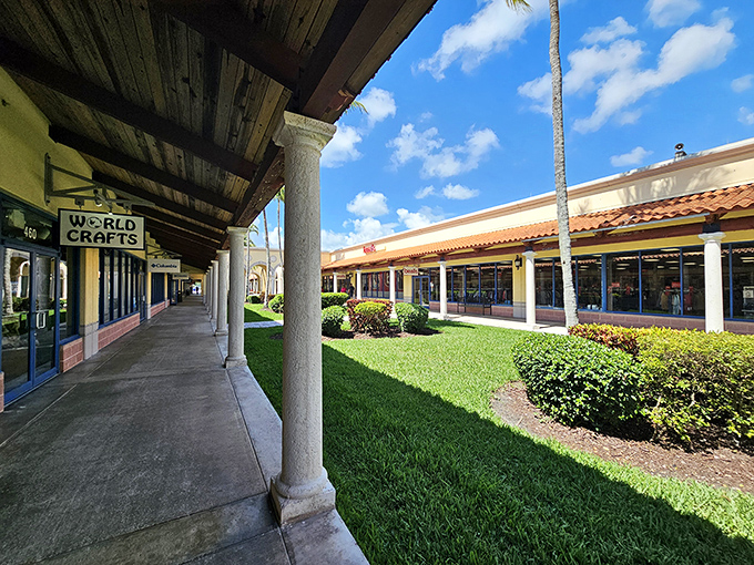 The World Crafts storefront beckons with its shaded walkway and lush landscaping—proof that outlet shopping doesn't have to feel like a fluorescent-lit endurance test.