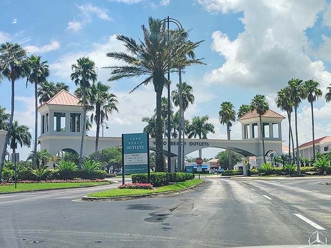 The grand entrance to Vero Beach Outlets welcomes shoppers with swaying palm trees and Mediterranean-inspired architecture – Florida's version of retail paradise.