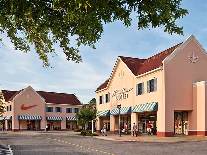 The iconic clock tower of North Georgia Premium Outlets stands tall against a blue Georgia sky, like a retail lighthouse guiding bargain hunters to shopping salvation.