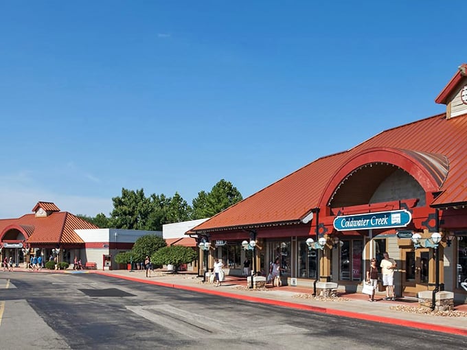 The distinctive terra-cotta roofs of Osage Beach Outlet Marketplace welcome bargain hunters like a retail oasis in the Ozarks landscape.