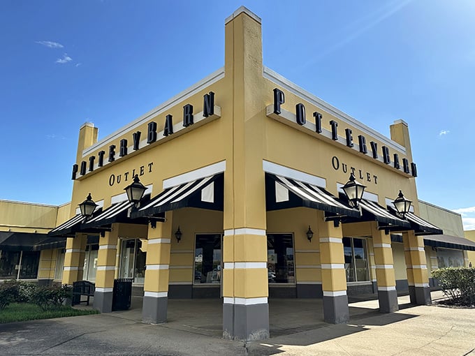 Pottery Barn's distinctive storefront beckons with its classic black-and-white awnings—a siren song for anyone who's ever dreamed of a Pinterest-worthy living room.