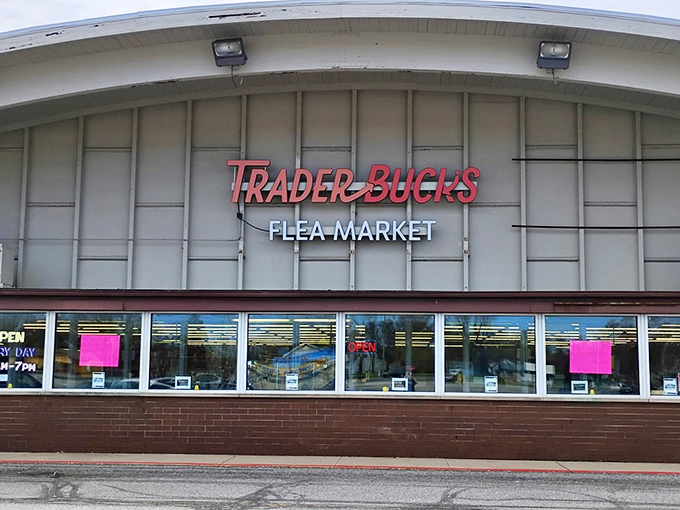 The iconic red and white sign of Trader Buck's beckons bargain hunters like a retail lighthouse, promising treasures within this unassuming Merrillville landmark.