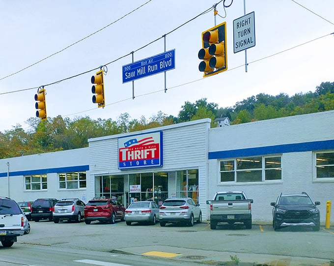 The white and blue exterior of Red White & Blue Thrift Store stands like a beacon of bargain hope along Saw Mill Run Boulevard, drawing treasure hunters from across Pennsylvania.