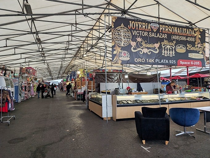 Under this vast canopy, treasure hunters navigate aisles of possibility. The jewelry display gleams with promise while shoppers embark on their bargain safari.