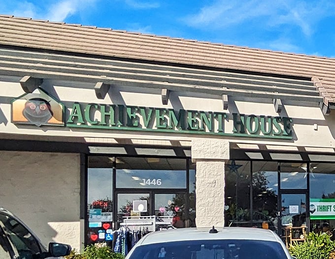 The welcoming storefront of Achievement House beckons with its cheerful owl logo—like a wise old friend inviting you to discover hidden treasures inside.