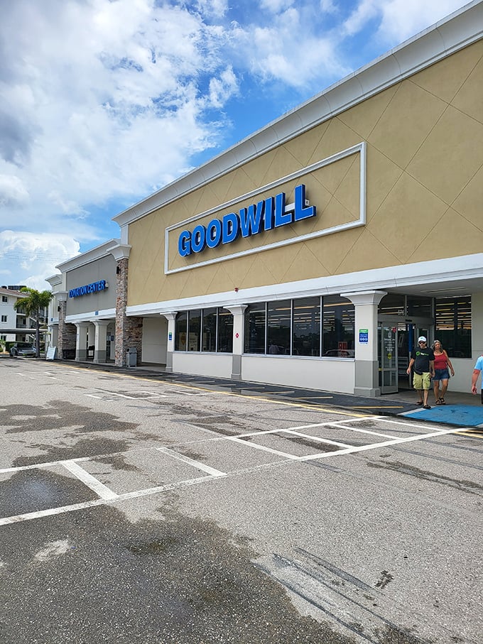 The blue Goodwill sign beckons like a lighthouse for bargain hunters. Venice's treasure trove awaits under those Florida skies.