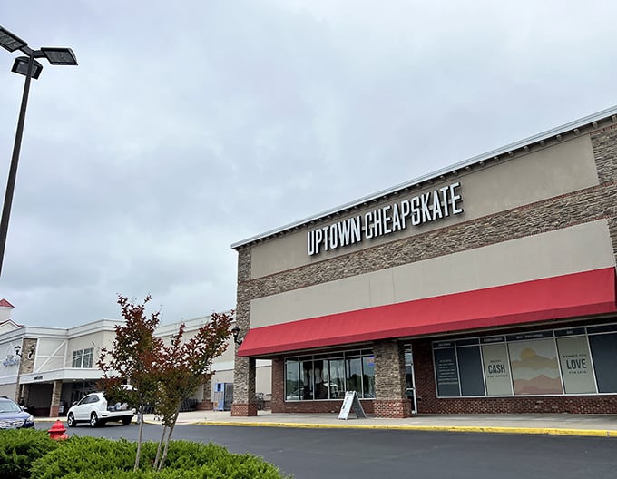 The stone facade and bold red awning of Uptown Cheapskate Timonium isn't just inviting—it's practically a siren call to bargain hunters everywhere.