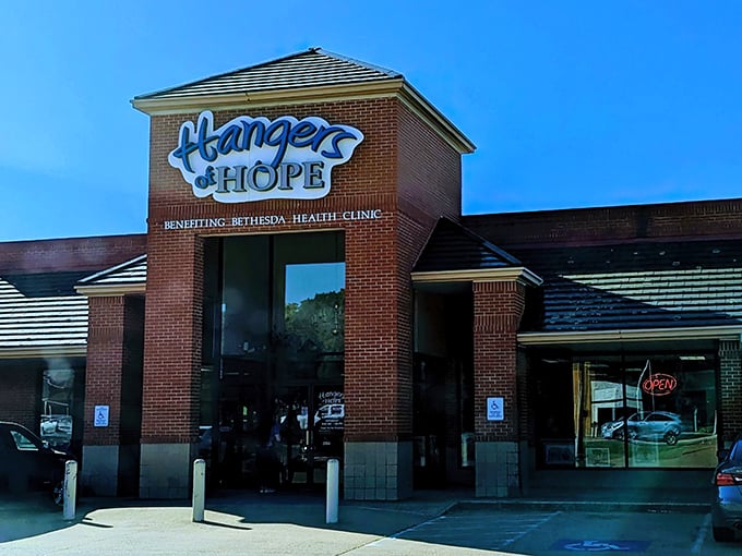 The bright blue Hangers of Hope sign against brick promises more than just retail therapy—it's shopping with a side of soul.