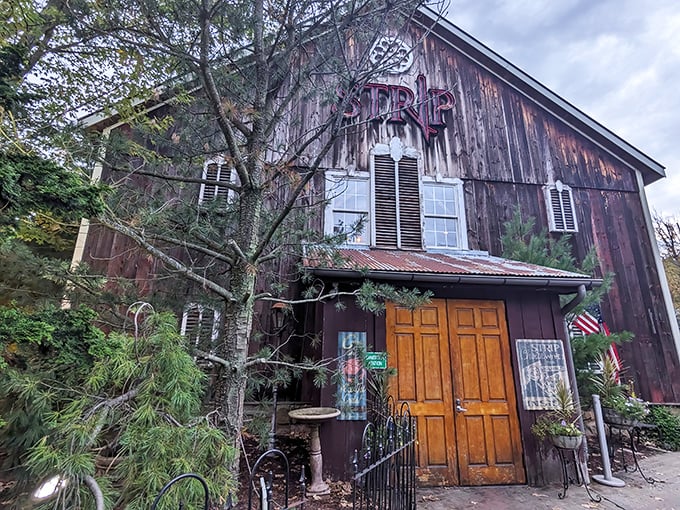 The weathered barn exterior of Strip Steakhouse stands like a culinary time capsule, its rustic charm belying the gastronomic treasures within.