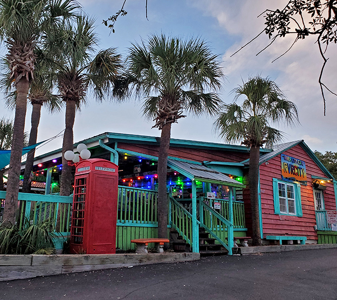 The coral-pink exterior with turquoise trim isn't just a building—it's a mood announcement. Beach vibes and burger dreams await!