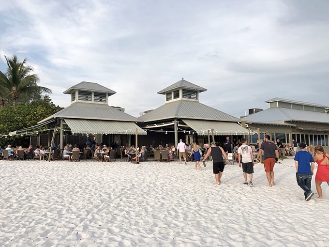 The Sandbar's distinctive twin-peaked roof rises from the powdery white sand like a beacon of culinary promise. Beach dining at its finest!