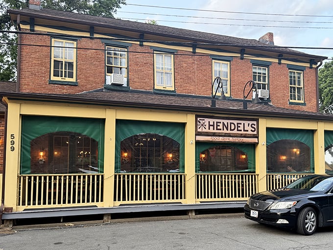 Brick, yellow trim, and those inviting green awnings – Hendel's exterior is like a warm hug in architectural form, beckoning hungry travelers to step inside.