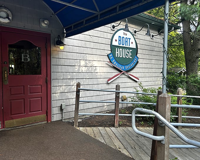 The welcoming red door and nautical-themed entrance of The Boat House beckons like a lighthouse to hungry travelers navigating the Pocono Mountains.
