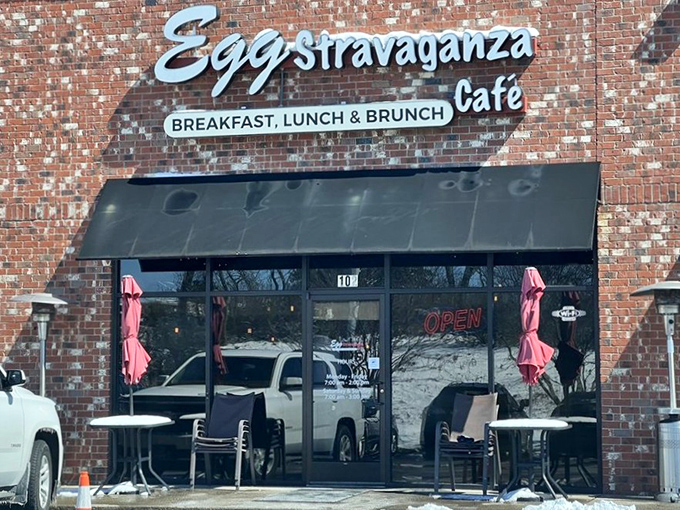 The brick exterior of Eggstravaganza Cafe promises little, delivers everything. Those packed parking spaces tell the real story—breakfast worth getting dressed for.