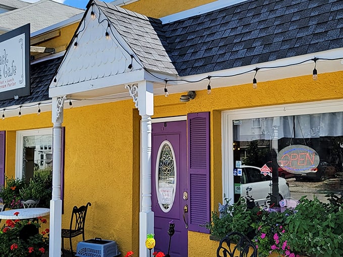 The purple door beckons like a royal invitation to this sunshine-yellow cafe, where string lights promise magic even in daylight hours.