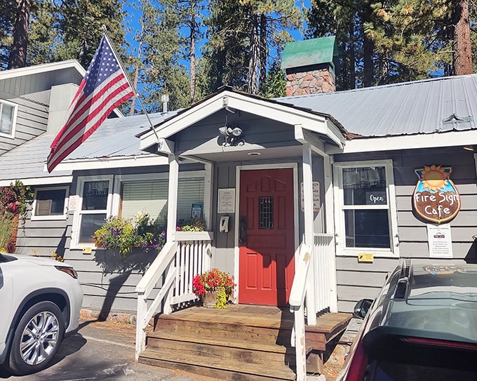 The quintessential Tahoe hideaway – a blue cabin nestled among pines, complete with white porch and American flag. Breakfast paradise awaits!