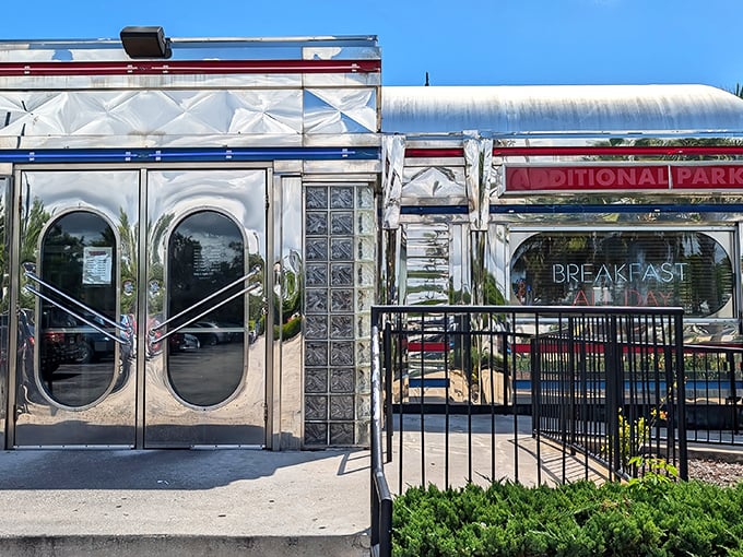 That iconic silver exterior with bold red lettering isn't just announcing a diner—it's promising a time-traveling culinary adventure in Dania Beach.