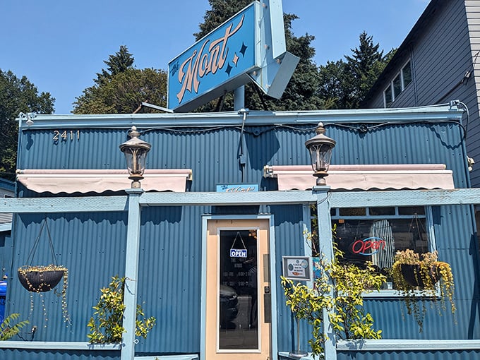 The Mont's vibrant blue exterior isn't just a building—it's a promise of good things to come, standing like a delicious beacon on Belmont Street.