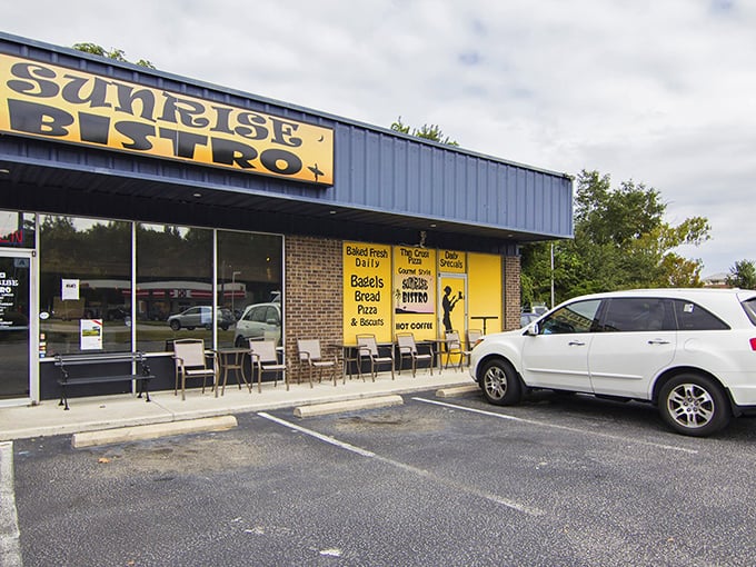 No fancy frills here—just that iconic blue-and-yellow Sunrise Bistro sign announcing you've arrived at breakfast paradise. The neon "OPEN" sign might as well say "Enter and be happy."