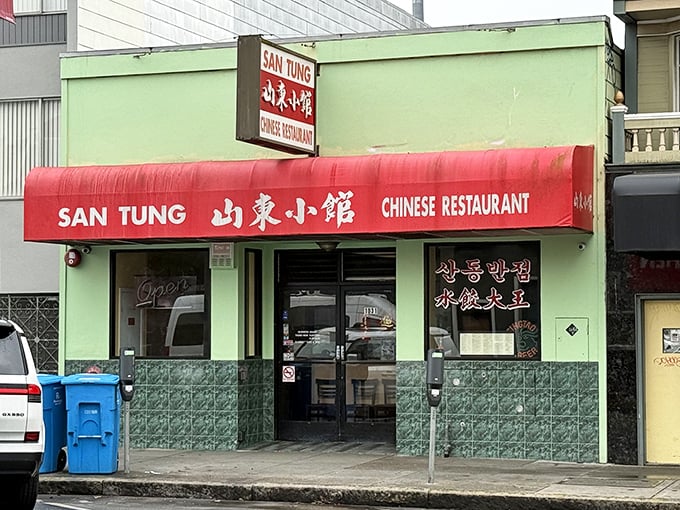 The unassuming mint-green exterior with bright red awning – San Francisco's culinary equivalent of Clark Kent's phone booth. Transformation happens inside.