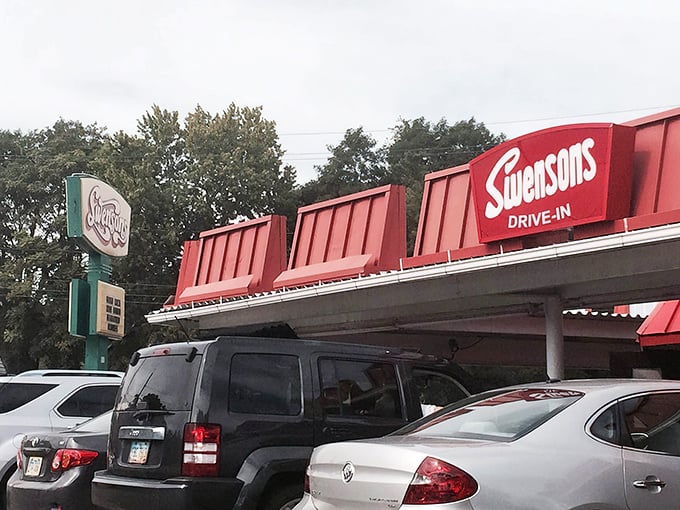 The iconic red roof of Swensons beckons like a beacon of burger bliss, promising a taste of Americana that's survived the fast-food revolution unscathed.
