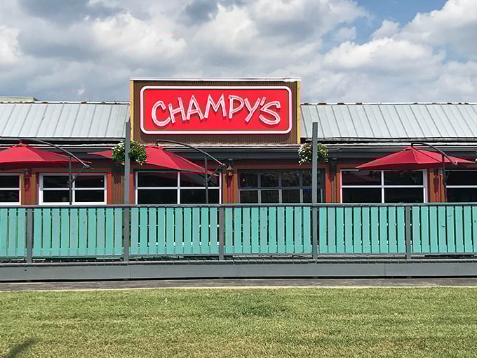Champy's distinctive turquoise fence and bright red sign create the perfect first impression—like a colorful welcome mat for your taste buds.