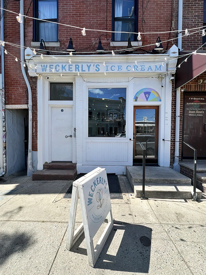 The storefront beckons like a frozen oasis, with twinkling lights and that perfect blue lettering promising sweet relief from Philadelphia's urban hustle.