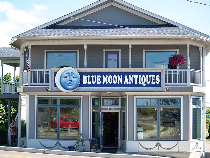 The iconic Blue Moon Antiques facade welcomes treasure hunters with its distinctive lunar logo and inviting wraparound porch—architectural eye candy for antiquing enthusiasts.